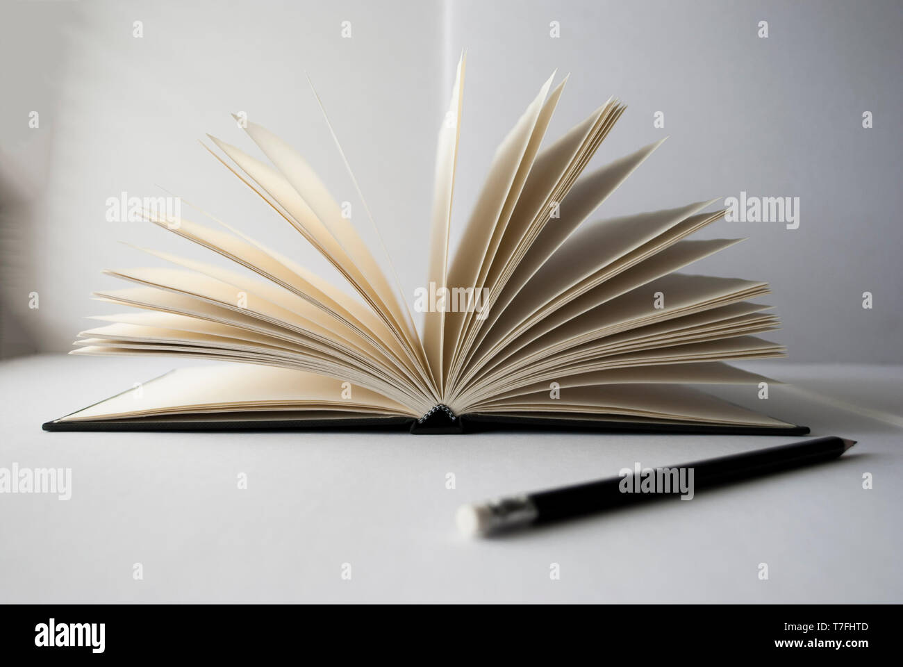 open book and pencil close up Stock Photo - Alamy