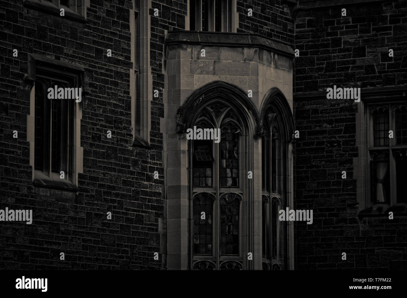 Exterior of an old gothic building with stone walls and bay window in ...