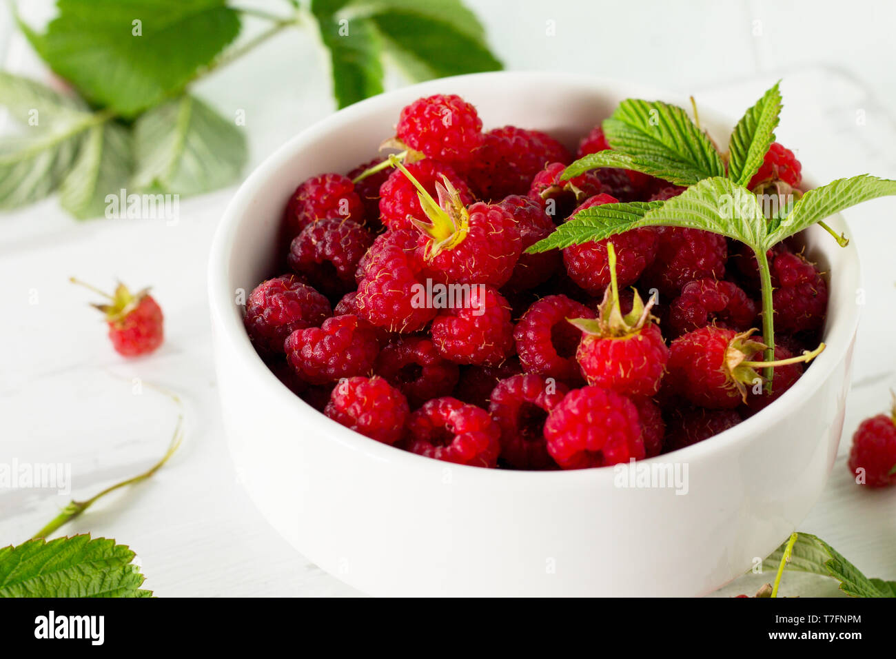 Berry raspberries on the kitchen wooden table. Concept fruit dessert ...