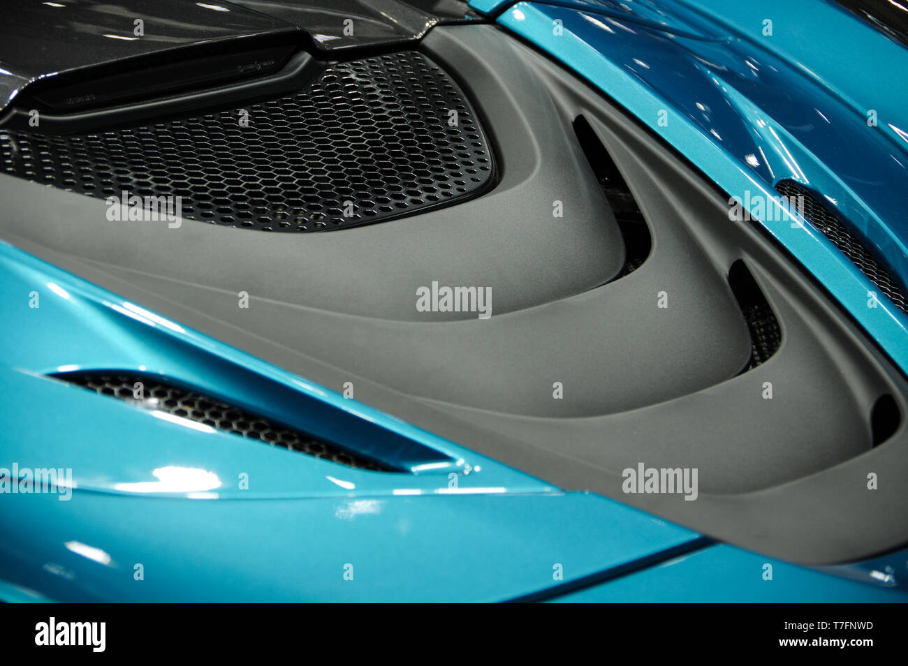 Modern blue car body carbon fiber engine close up view Stock Photo - Alamy