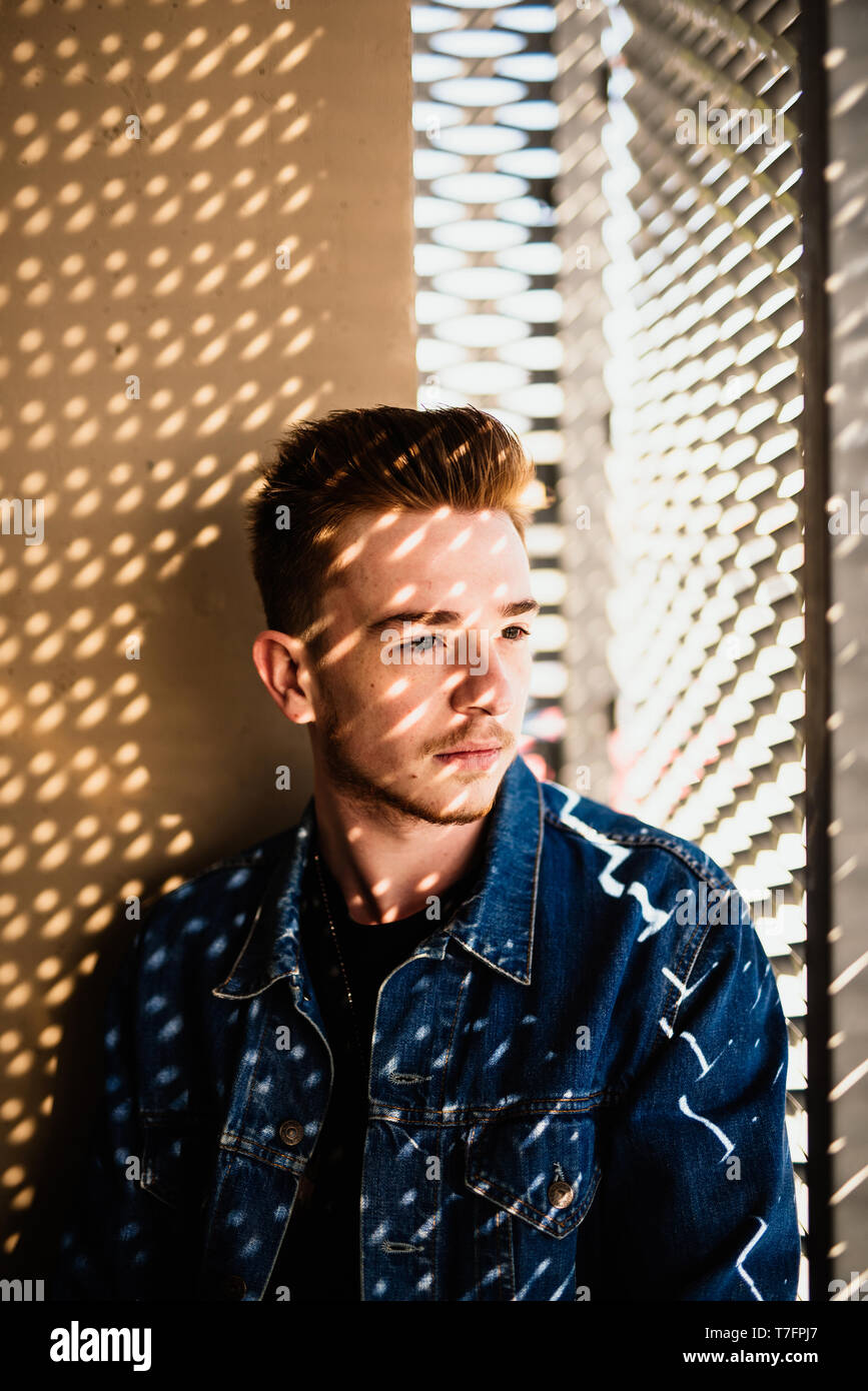 Young man with lights on his face Stock Photo - Alamy