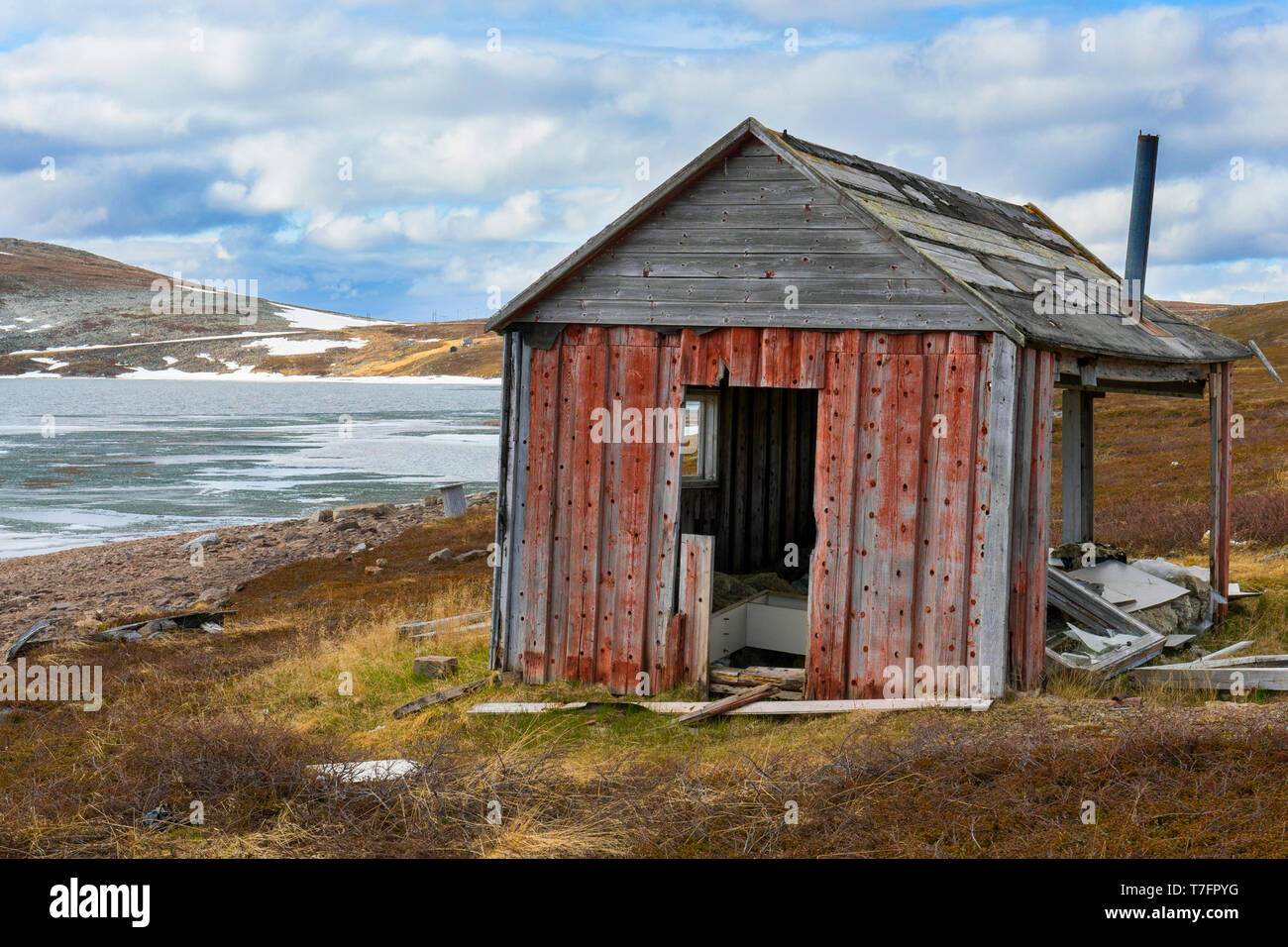 Old House at Båtsfjordfjellet, tundra landscape with frozen lake and ...