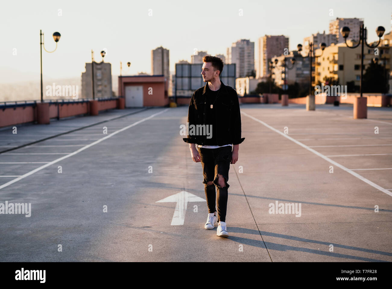 Young man walking on the roof Stock Photo - Alamy