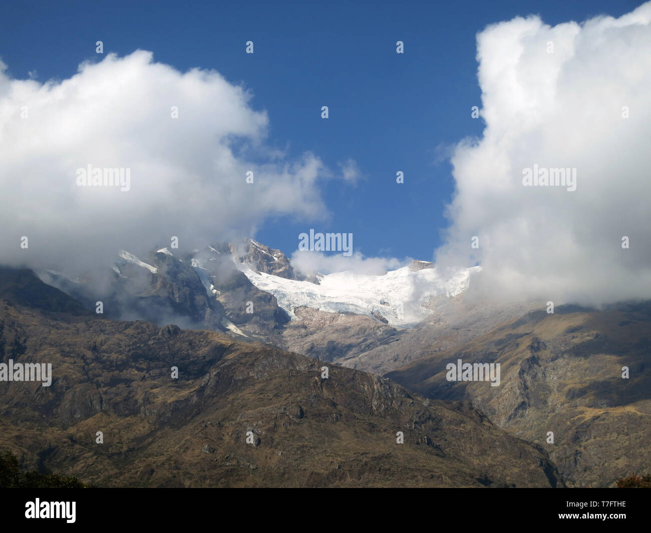 Clouds over snow capped Andean peak with huge glacier near Abra Malaga ...