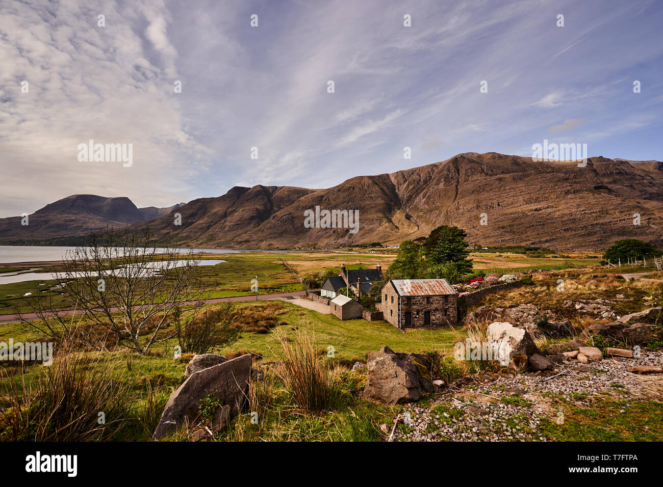 Small cottage with red roof beside Loch Shieldaig in Torridon, on North ...