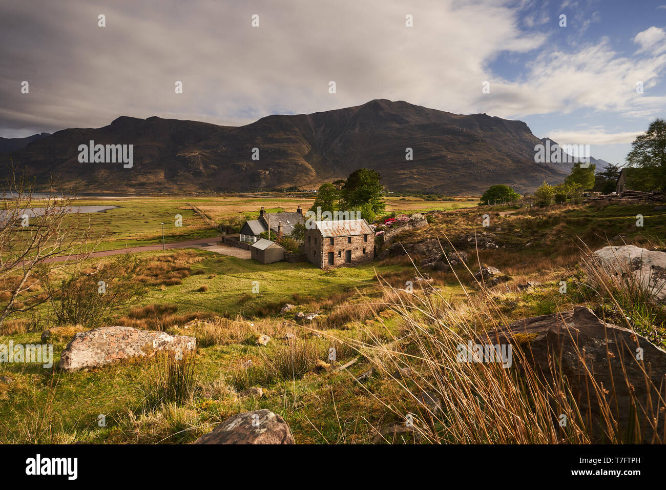 Small cottage with red roof beside Loch Shieldaig in Torridon, on North ...