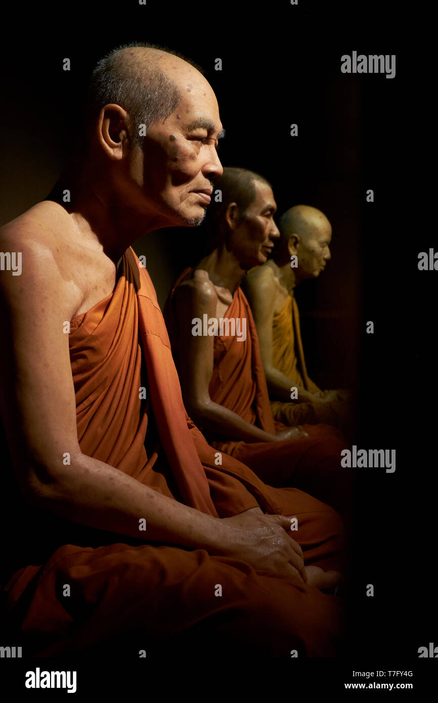 A group of monks under dramatic lighting at the Human Imagery Museum in ...
