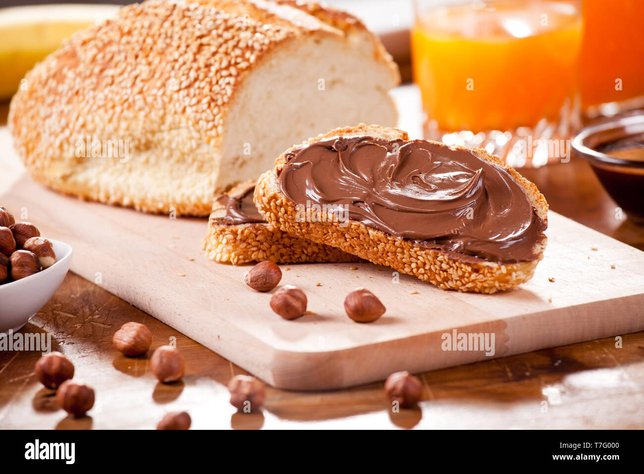 Couple of slices of bread with nutella and some fruit juice Stock Photo ...