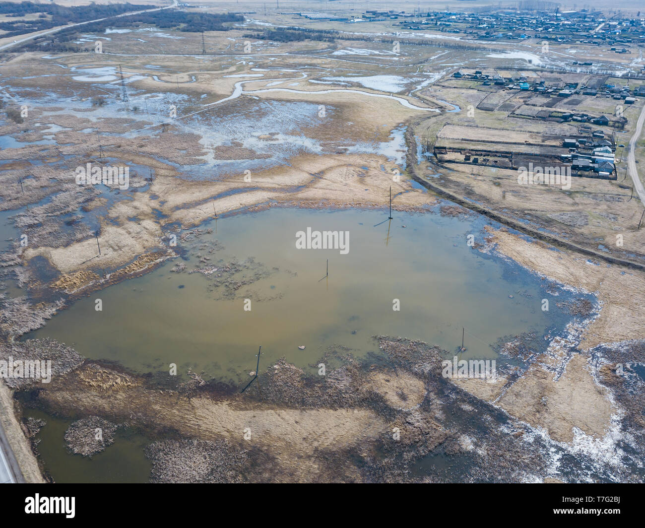 Aerial view of a marshland near a highway with an asphalt road during a ...