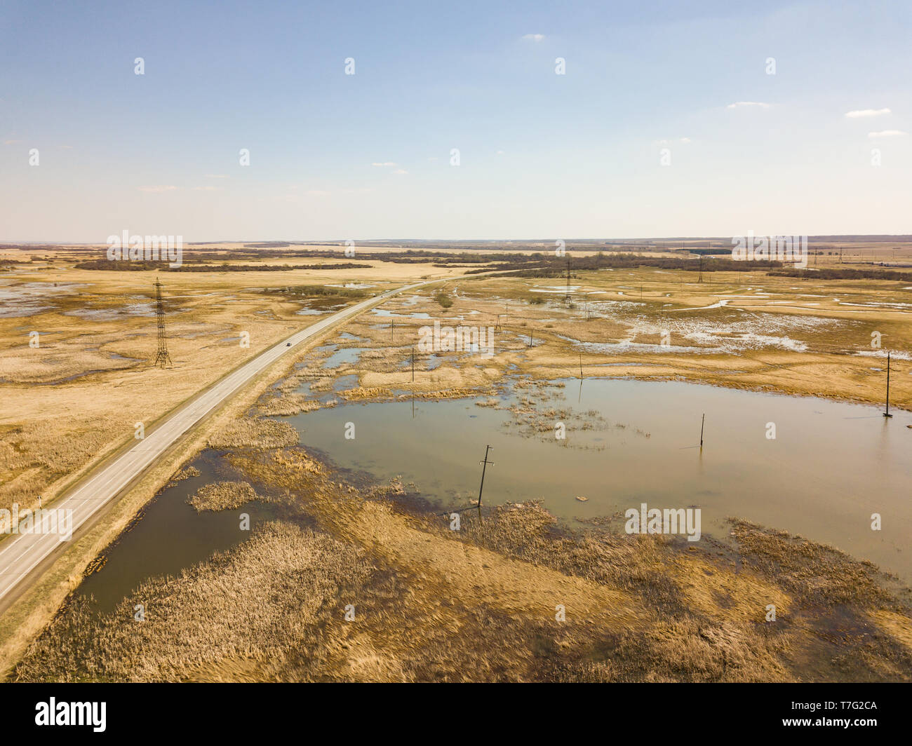 Aerial view of a marshland near a highway with an asphalt road during a ...