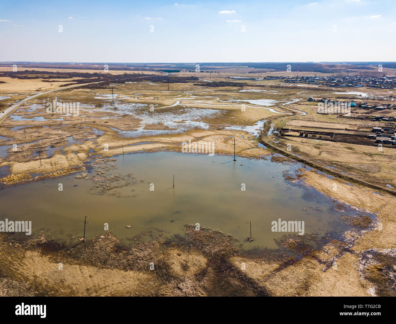 Aerial view of a marshland near a highway with an asphalt road during a ...