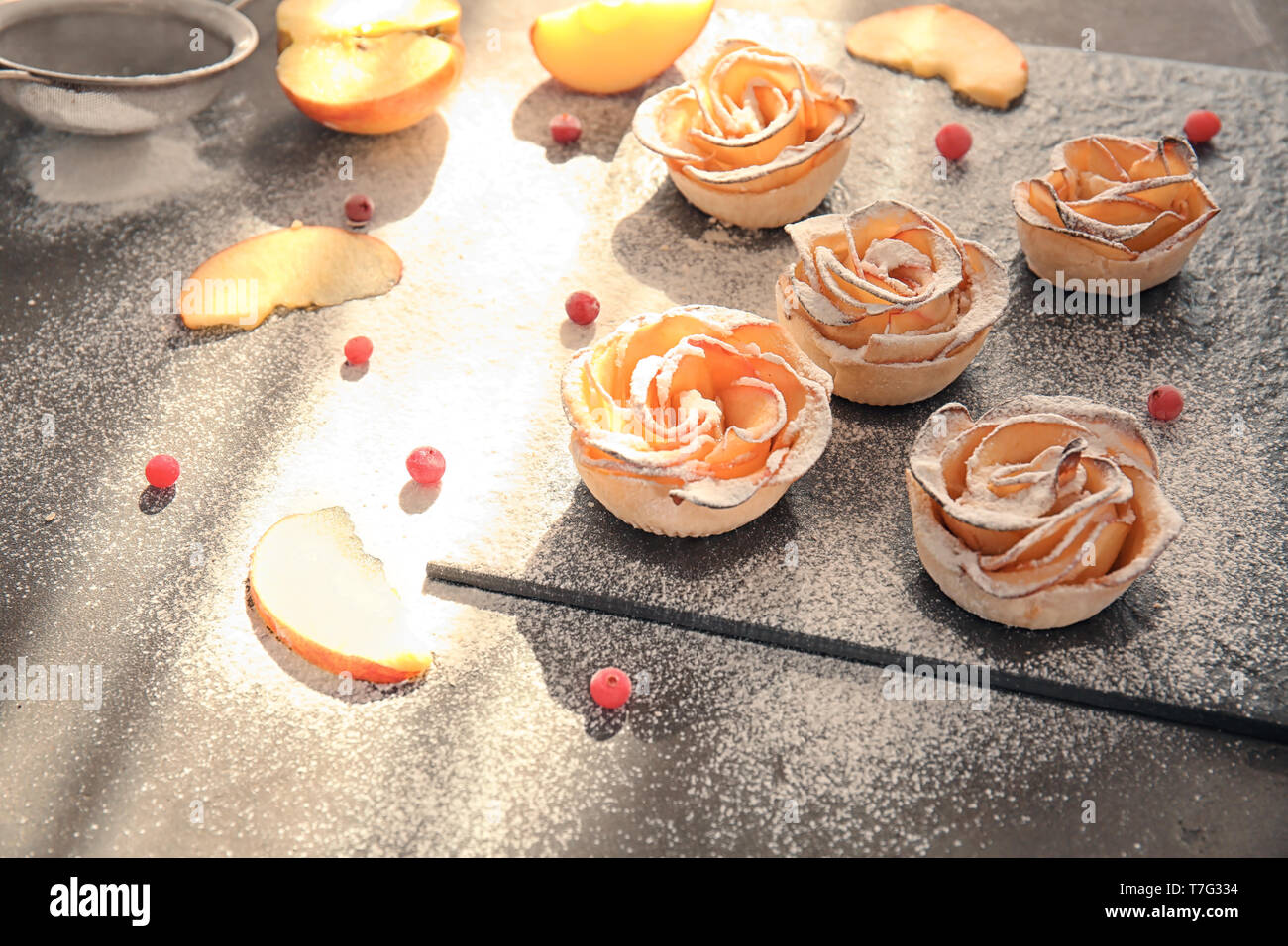 Slate board with tasty apple roses from puff pastry on table Stock ...