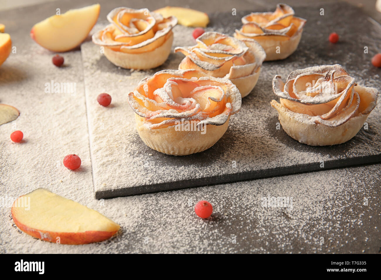 Slate board with tasty apple roses from puff pastry on table Stock ...