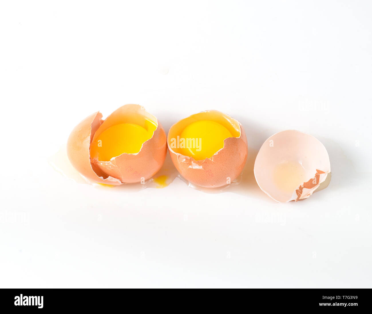 Broken chicken eggs isolated on white background Stock Photo - Alamy