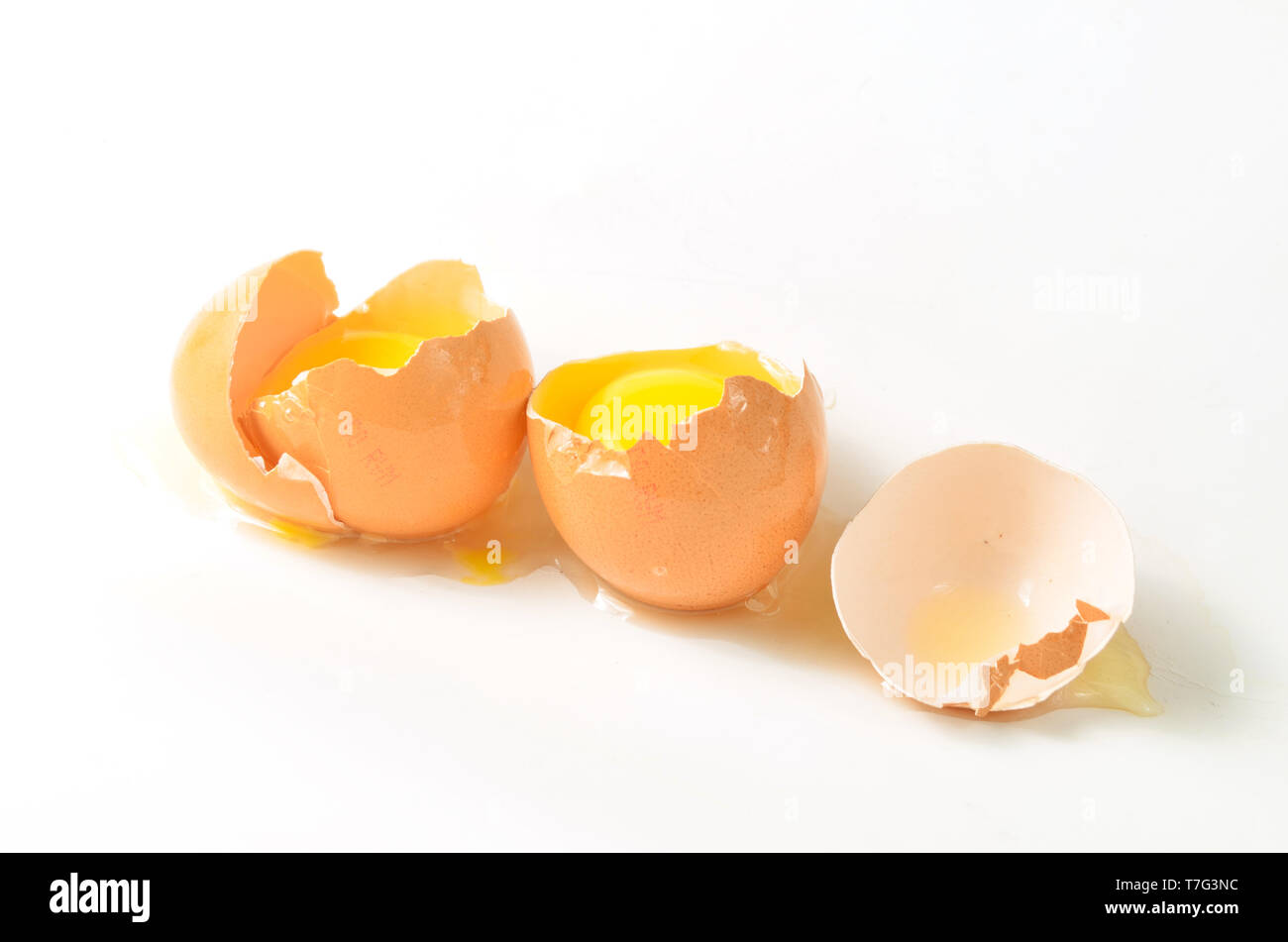Broken chicken eggs isolated on white background Stock Photo - Alamy