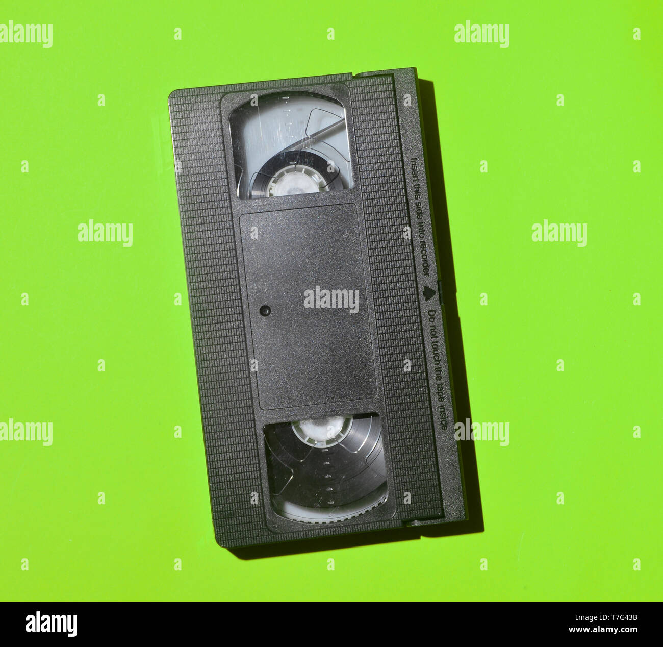 Retro videocassette from 80s on a green background. Obsolete media ...