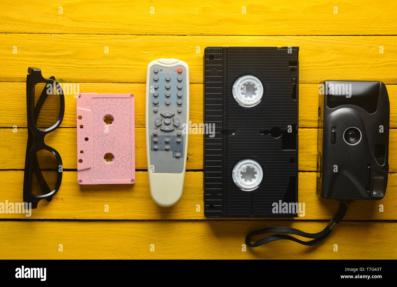 Audio cassette, vhs, 3d glasses, tv remote, hipster film camera on a ...