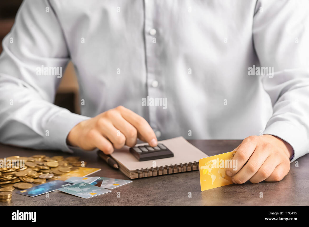 Man counting income at table. Savings concept Stock Photo - Alamy