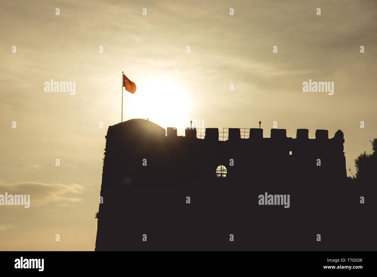 turkish castle with a turkish flag in a sunset Stock Photo - Alamy
