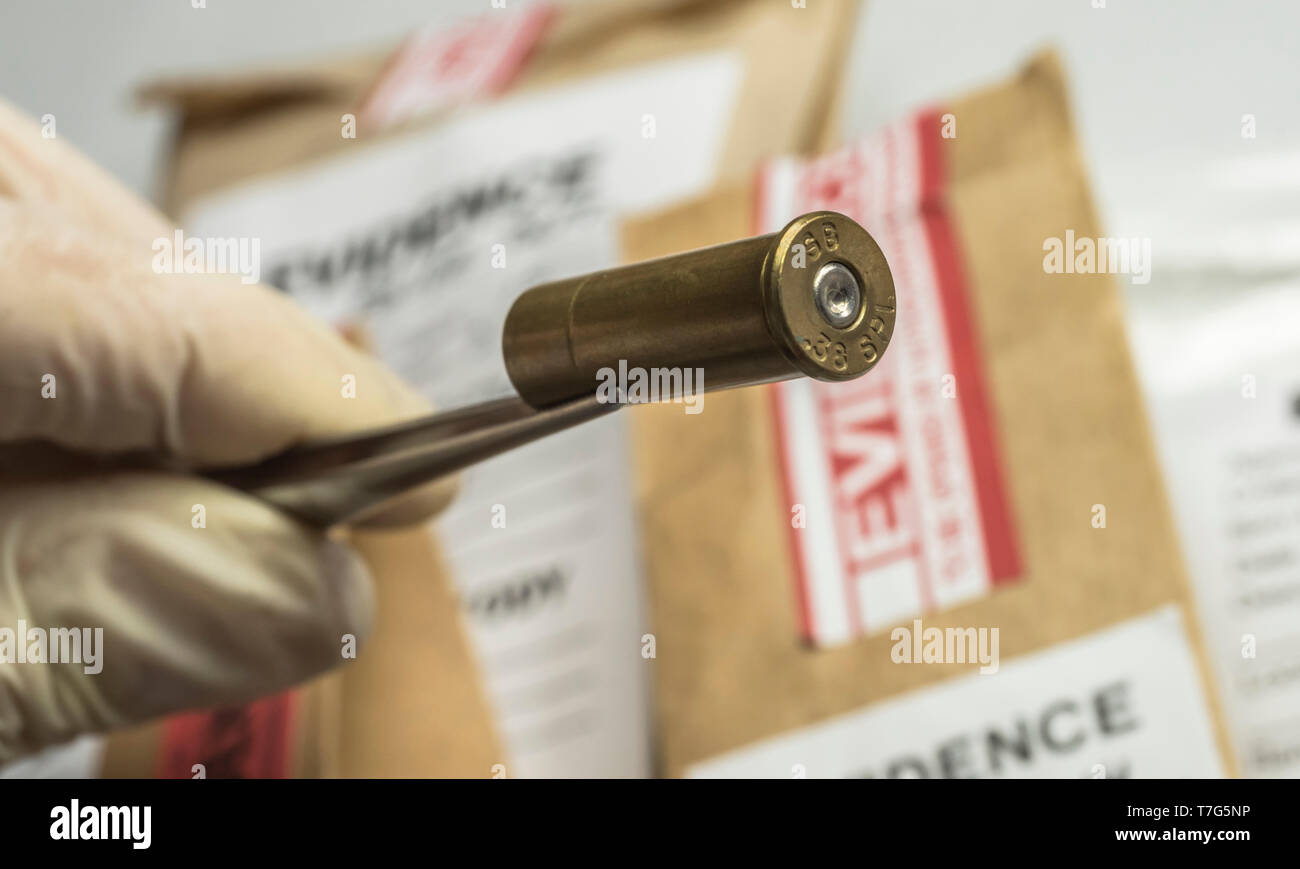 Criminalistic Laboratory, Scientific police officer holds bullet tips ...