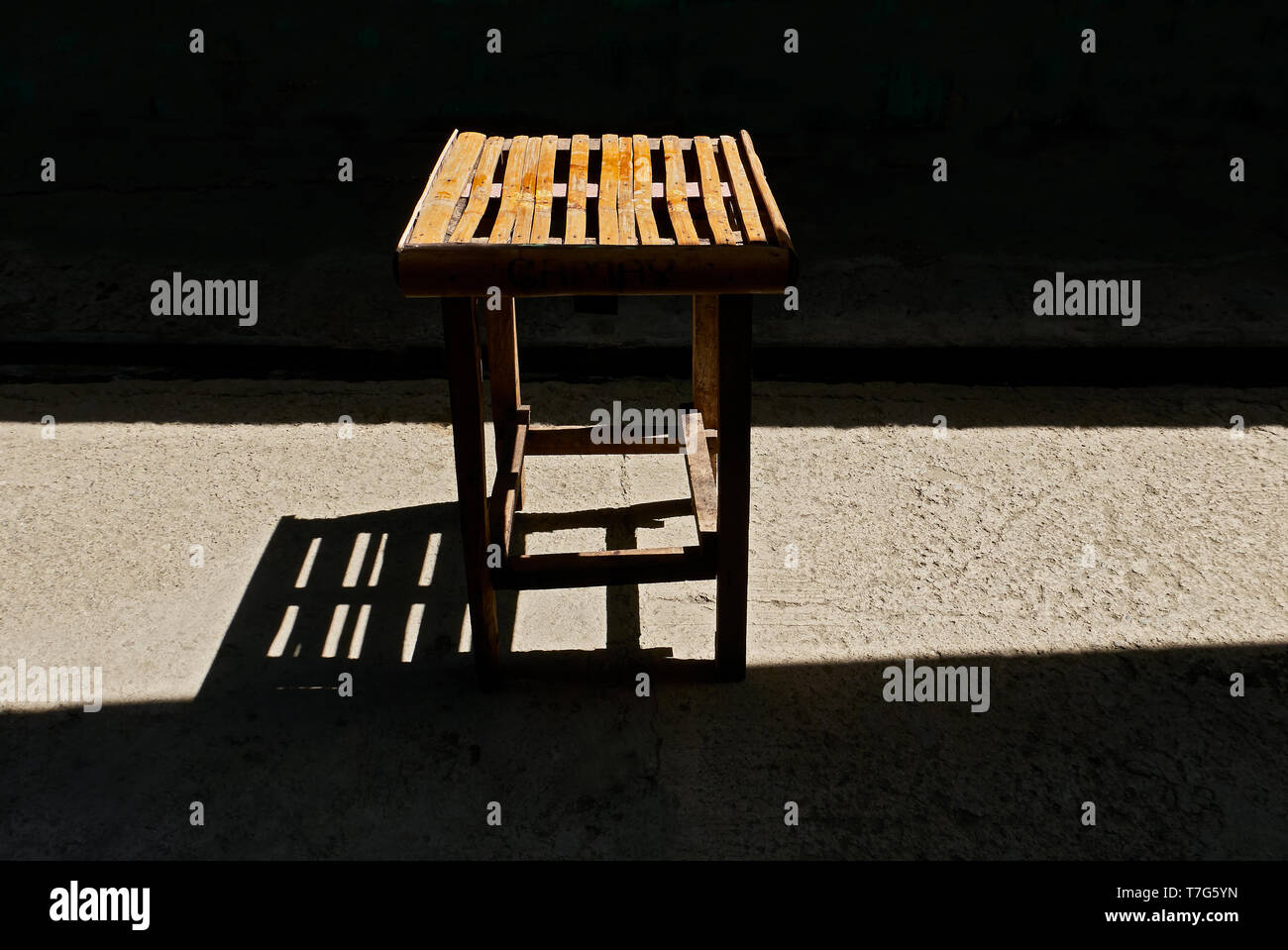A small simple self-made table out of wood and bamboo leaving long ...