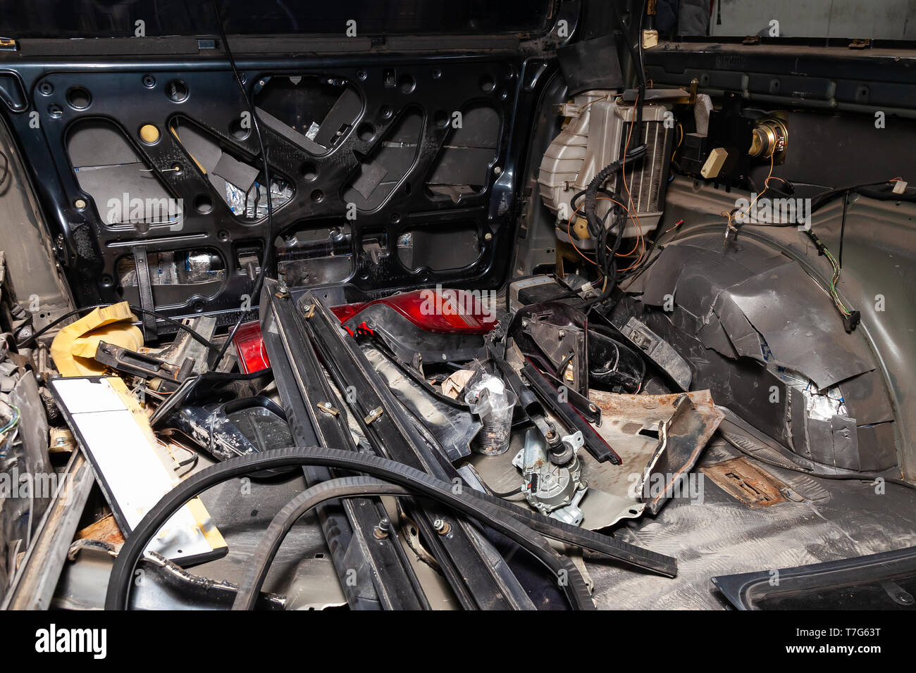 Car interior in the back of a van with a disassembled lining, seats ...
