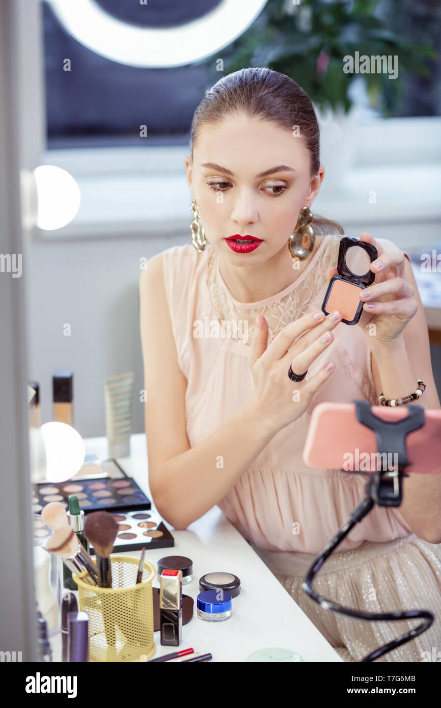 Pretty nice young woman showing her cosmetics Stock Photo - Alamy
