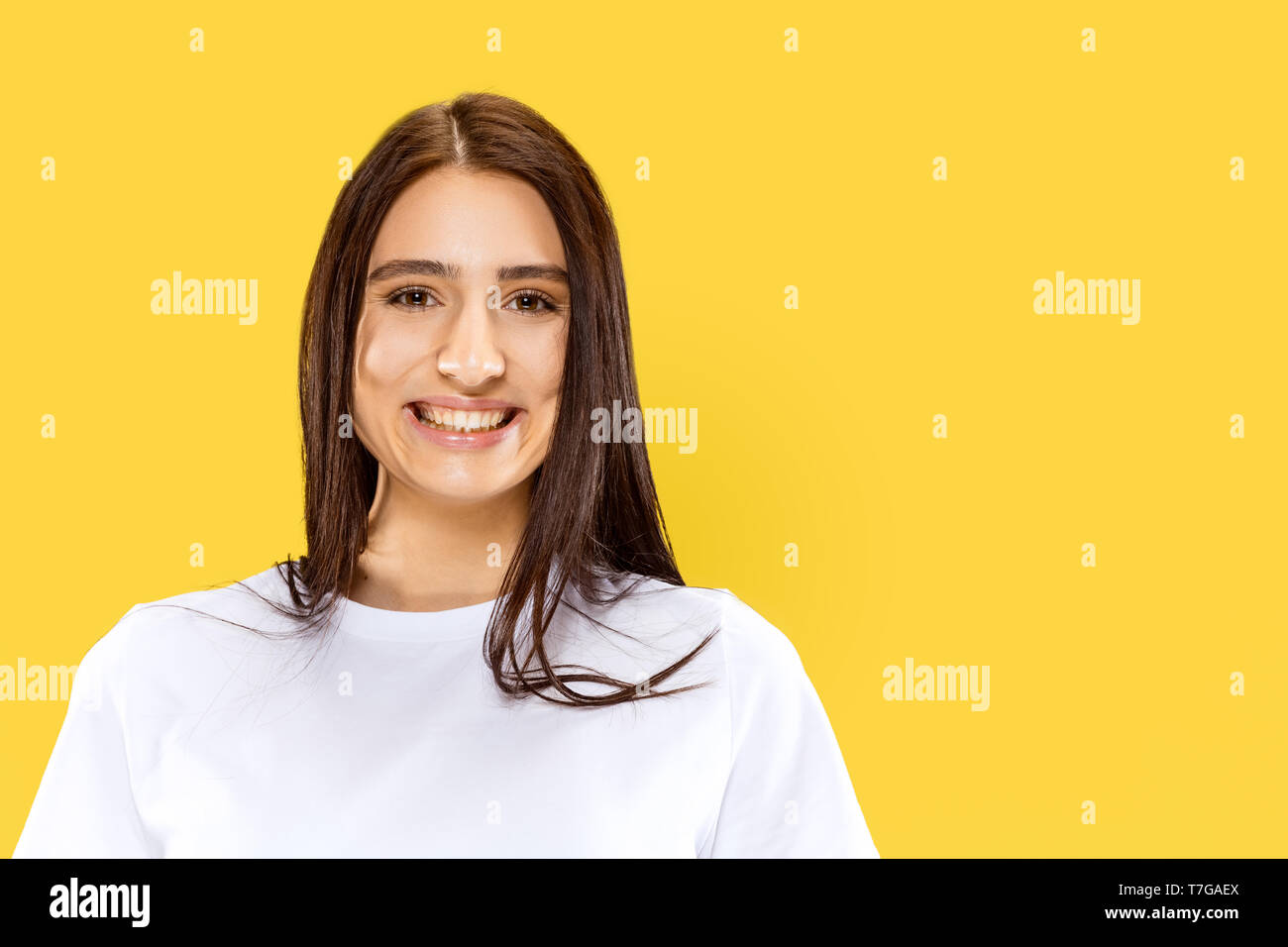 Happy attractive smiling girl. Beautiful female half-length portrait ...