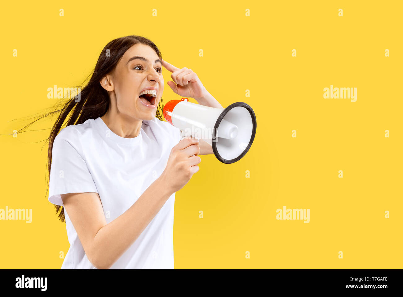 Screaming girl with the mouthpiece. Beautiful female half-length ...