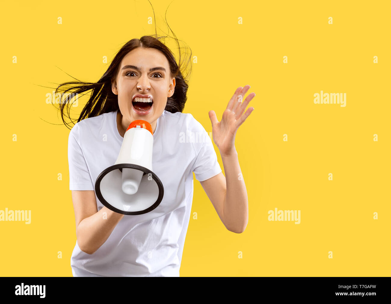 Screaming girl with the mouthpiece. Beautiful female half-length ...