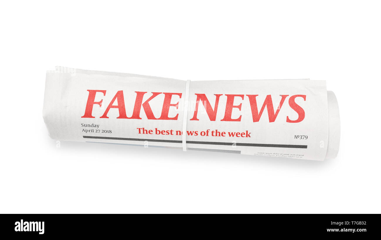 Rolled newspaper on white background Stock Photo - Alamy
