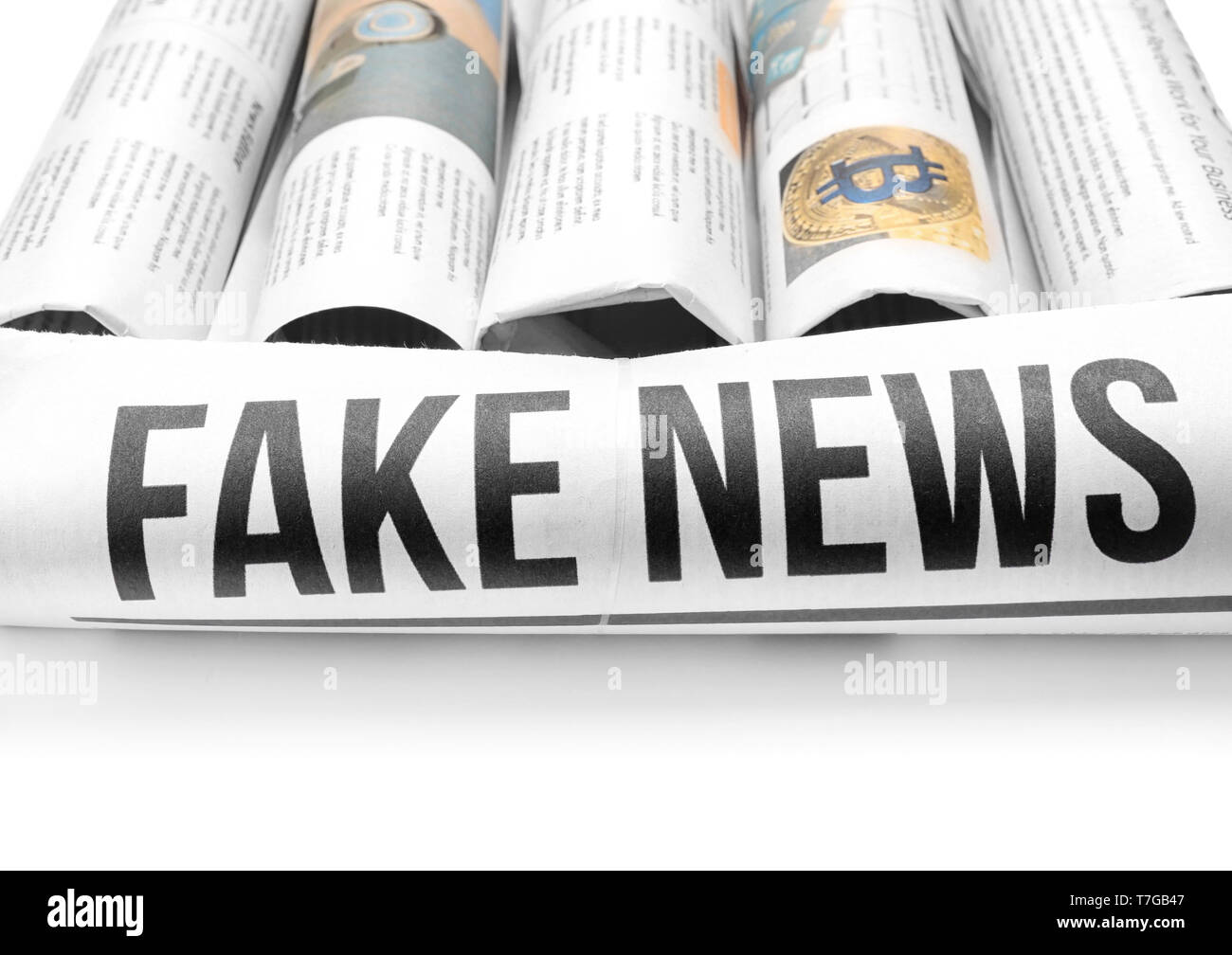 Rolled newspapers on white background Stock Photo - Alamy
