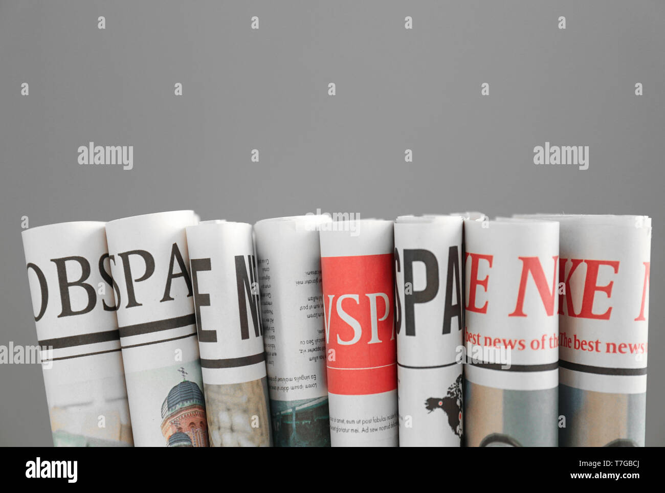 Folded newspapers on grey background Stock Photo - Alamy