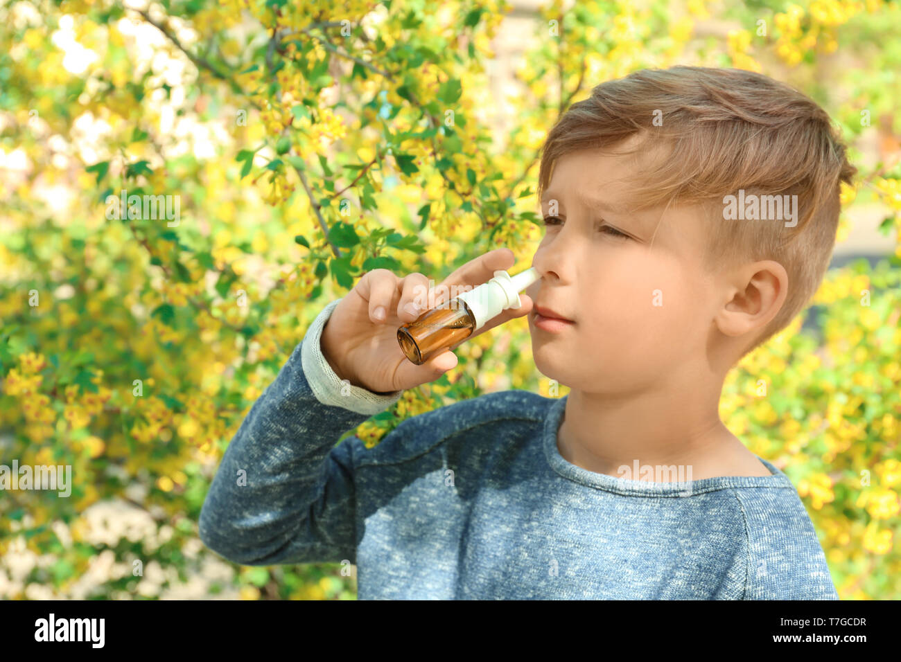 Little boy using nasal drops near blooming tree. Allergy concept Stock ...