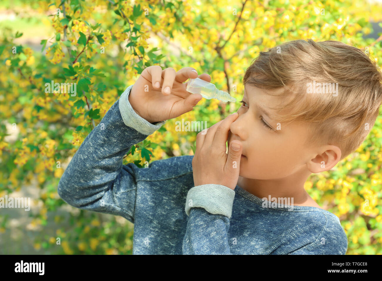 Little boy using eye drops near blooming tree. Allergy concept Stock ...