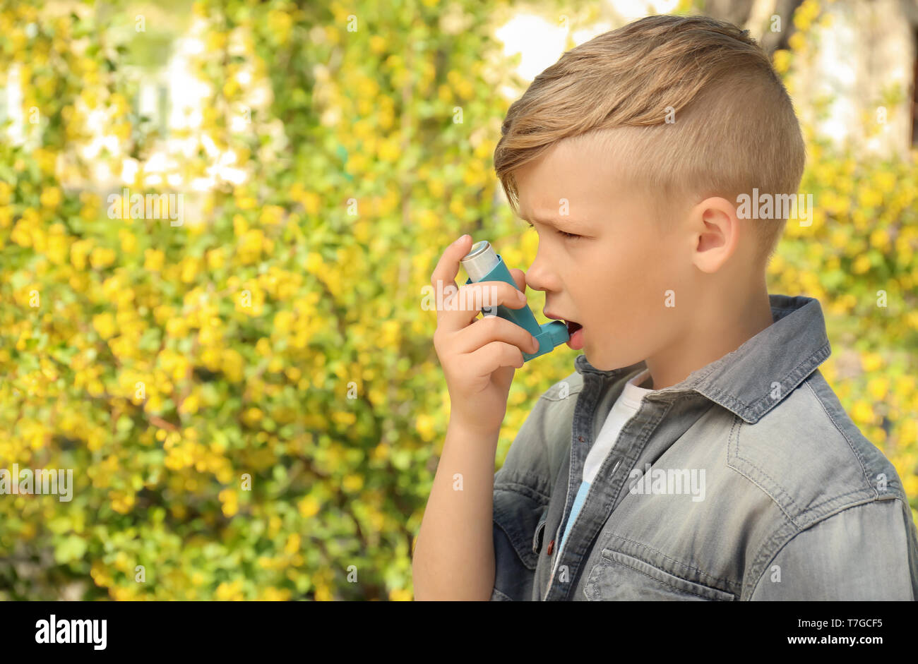Little boy using inhaler near blooming tree. Allergy concept Stock ...