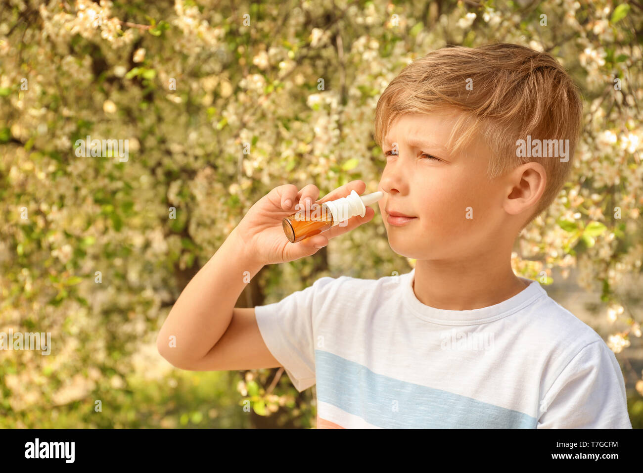 Little boy using nasal drops near blooming tree. Allergy concept Stock ...