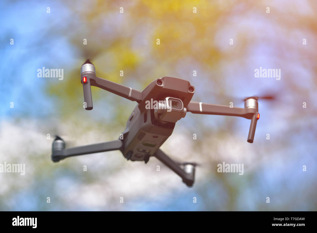 Flying drone with camera hovering inside a forrest, natural background ...