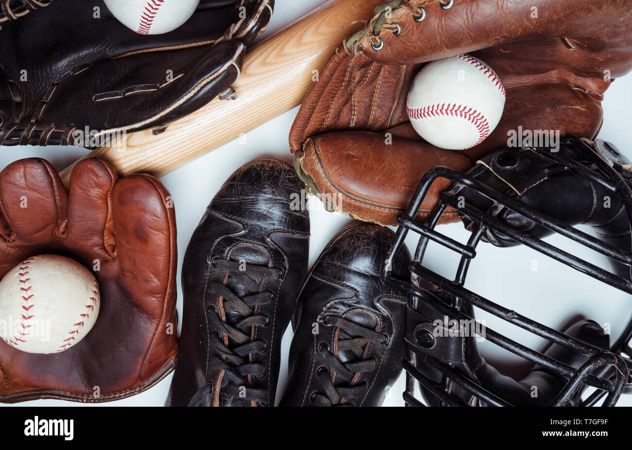 Vintage and modern baseball equipment including bats, balls gloves and ...