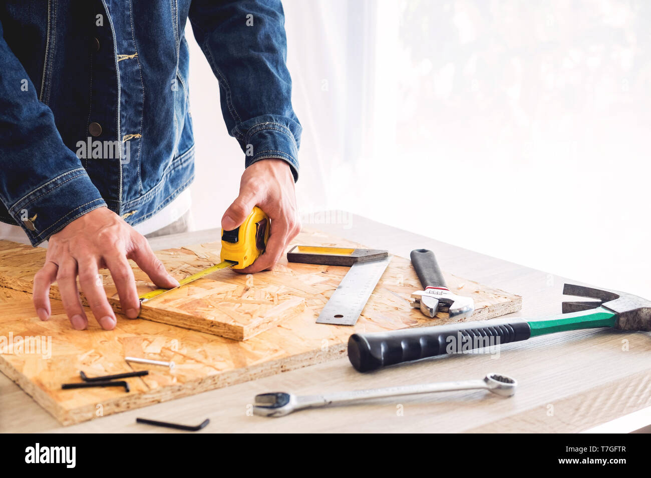 Carpenter working carefully looking at the plans work in carpentry. He ...