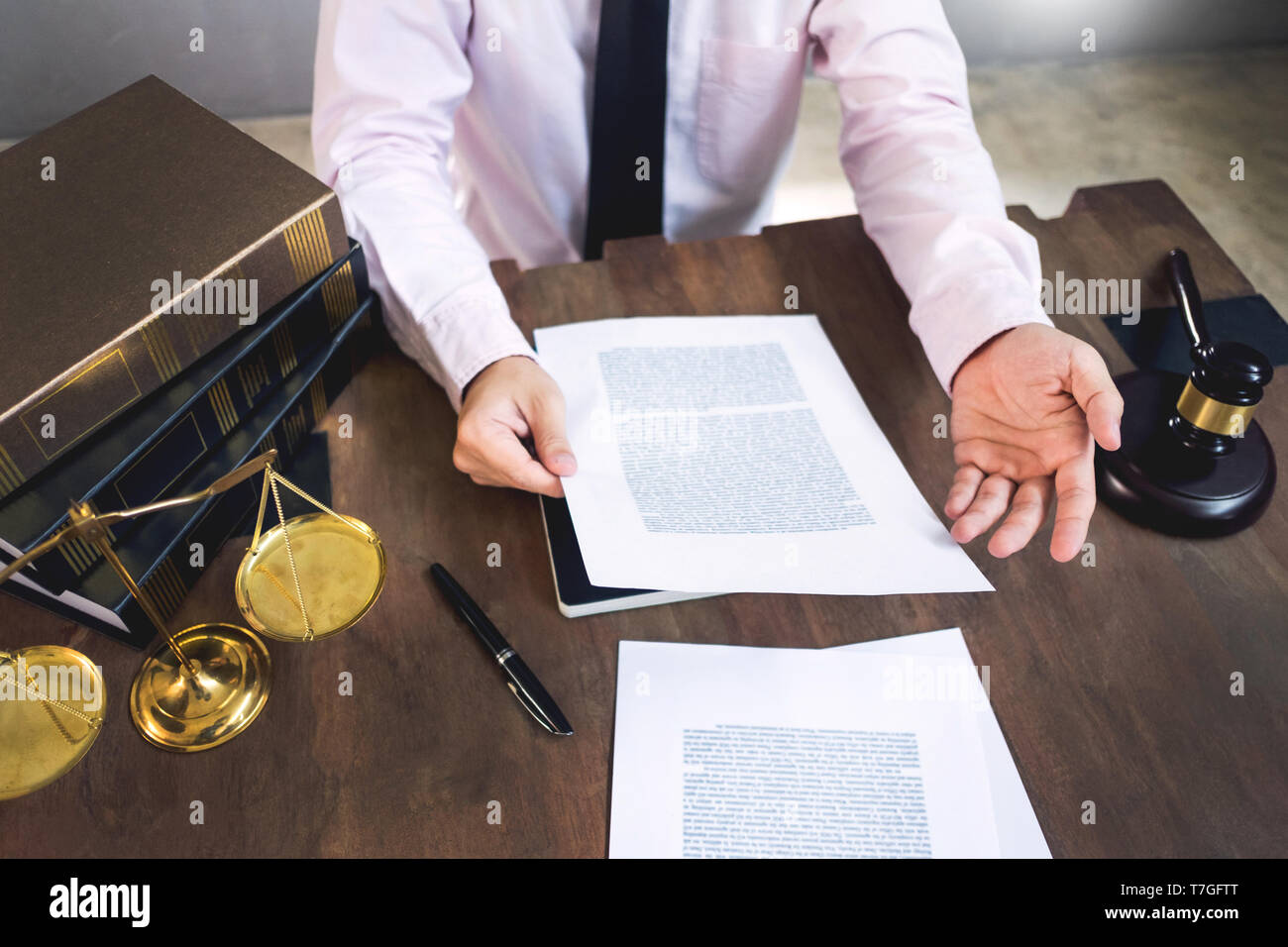 lawyer judge reading documents at desk in courtroom working on wooden ...