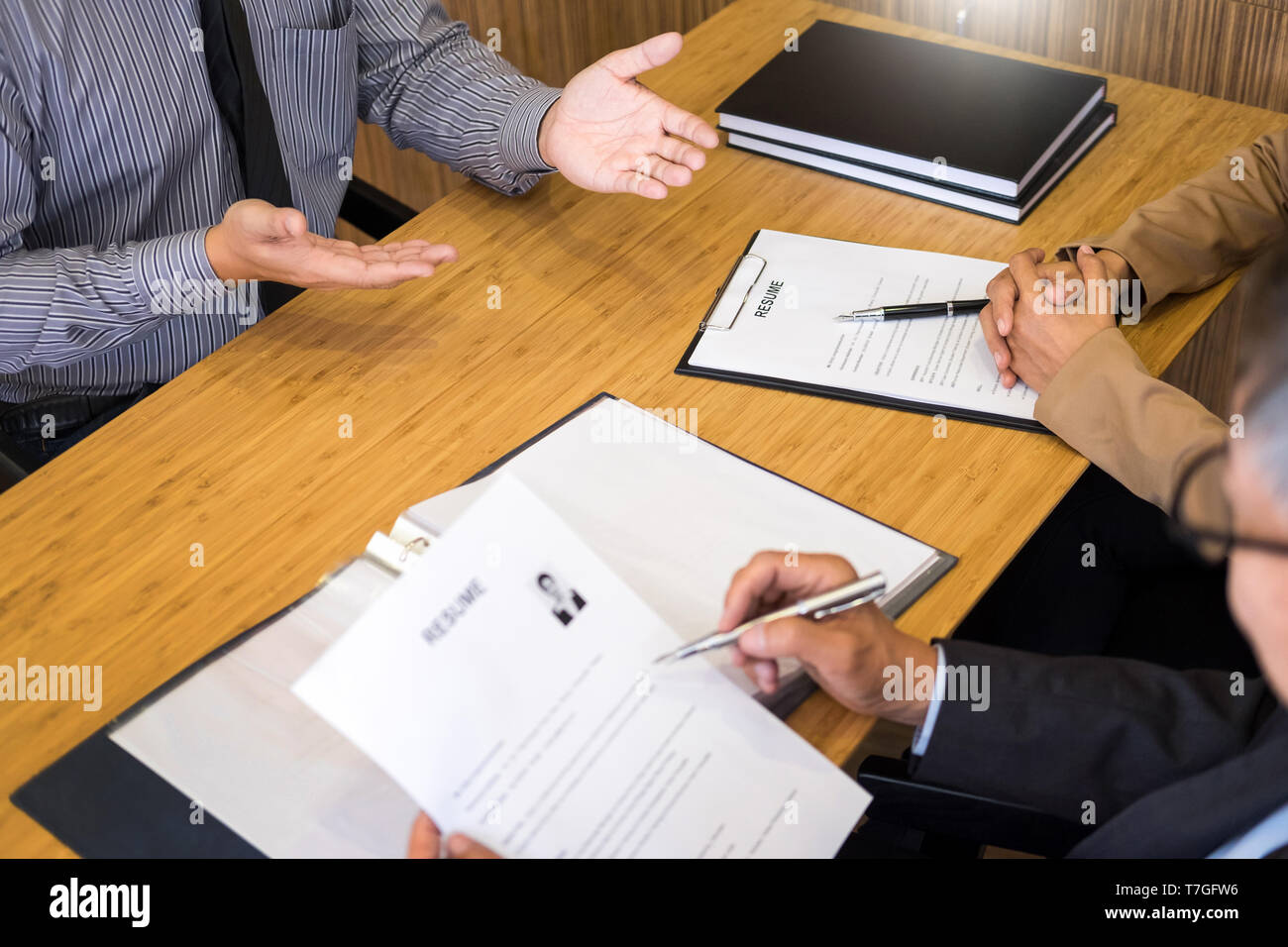 young man explaining about his profile to business managers sitting in ...