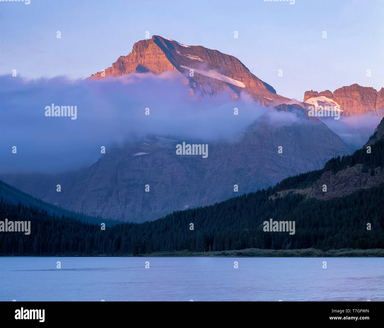 USA, Montana, Glacier National Park, Early morning light on fog ...