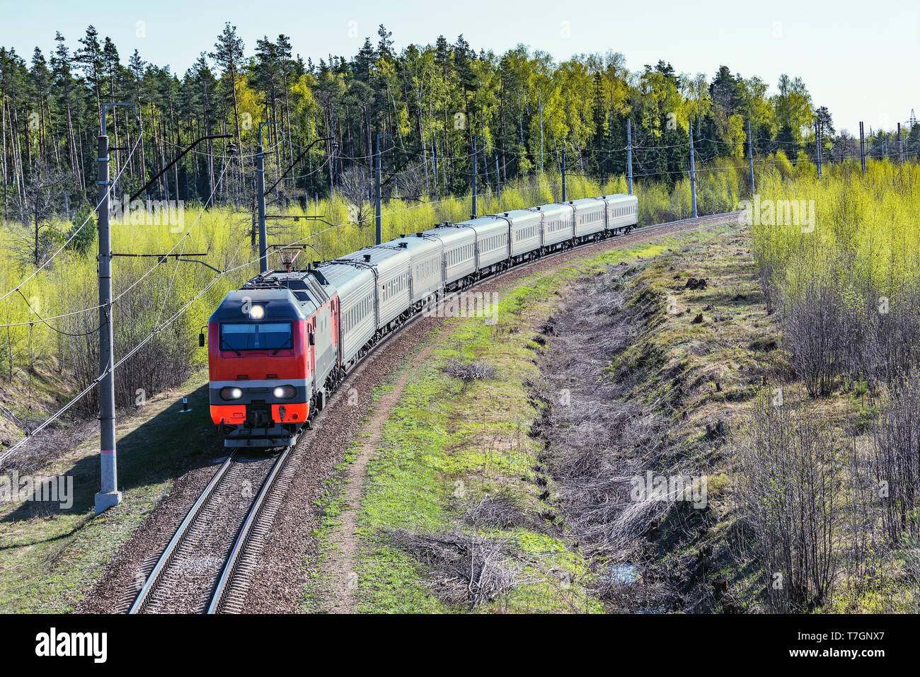Passenger train approaches to the station at spring morning time Stock ...