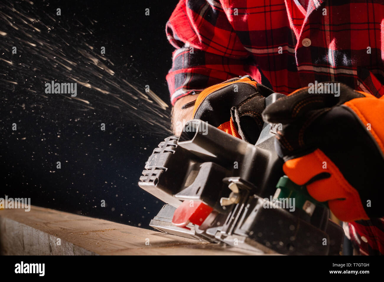 Carpenter works with electrical planer hi-res stock photography and ...