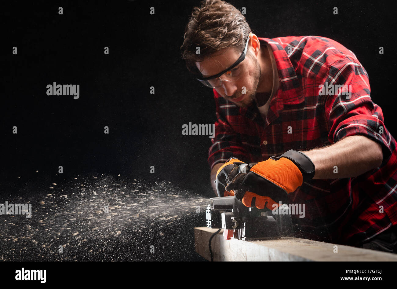 Carpenter works with electrical planer hi-res stock photography and ...