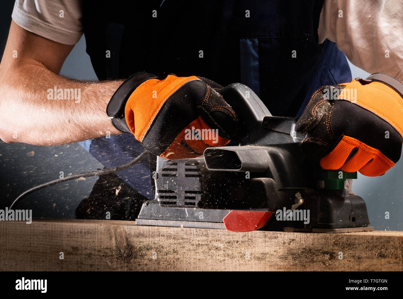 Carpenter works with electrical planer hi-res stock photography and ...