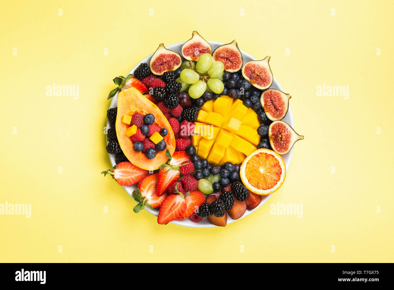 Delicious fruit platter mango papaya oranges figs berries on round ...