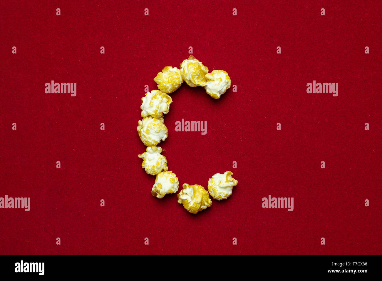 English alphabet from cinema popcorn. Letter C. Red background for ...