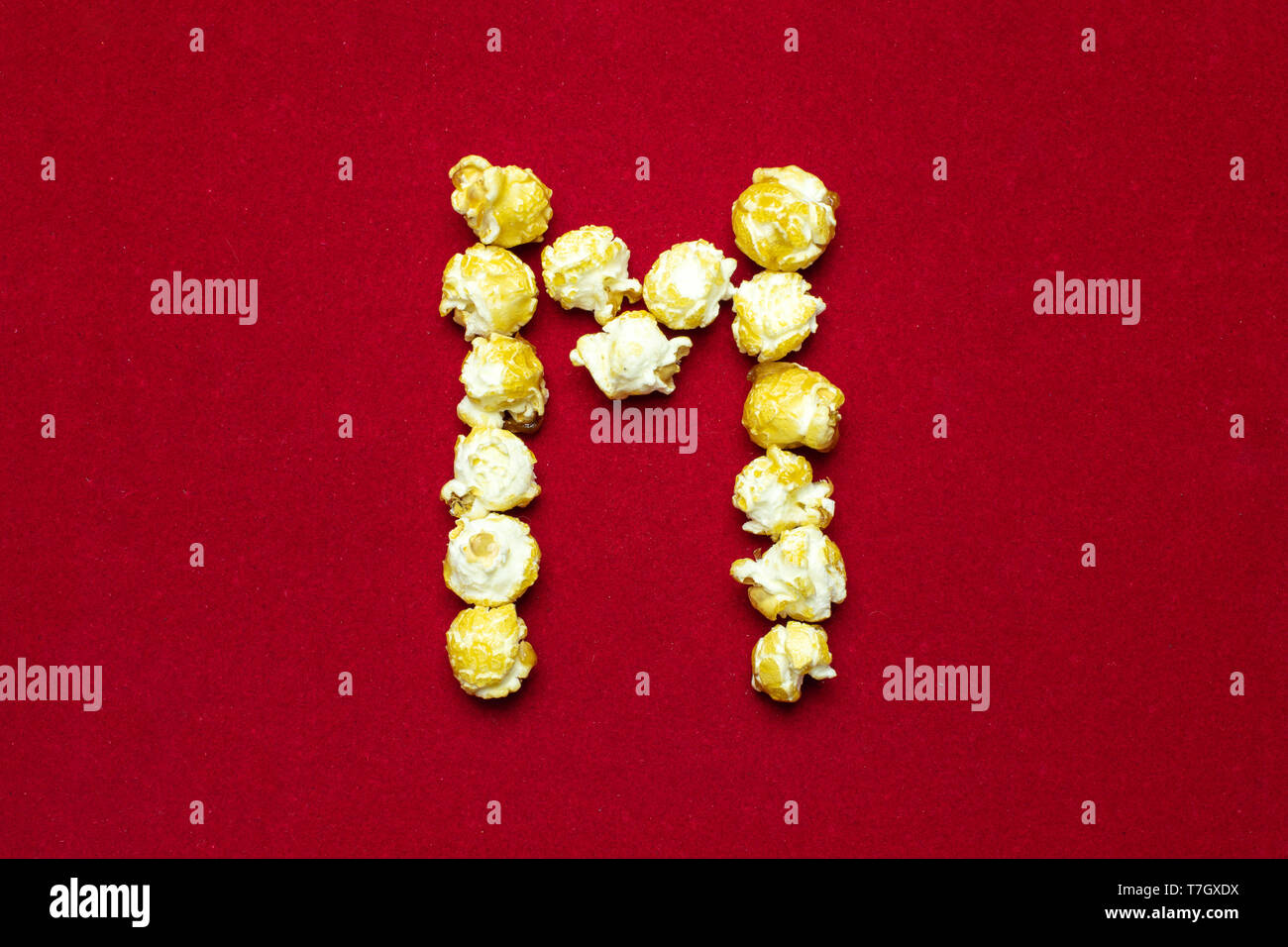English alphabet from cinema popcorn. Letter M. Red background for ...